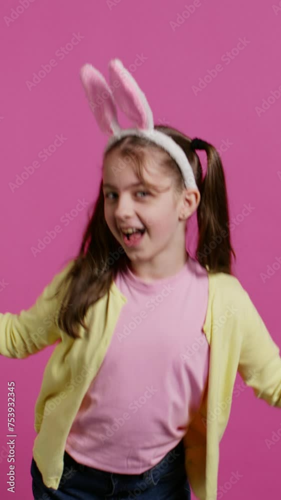 Adorable little girl playing peek a boo game in studio, showing her ...