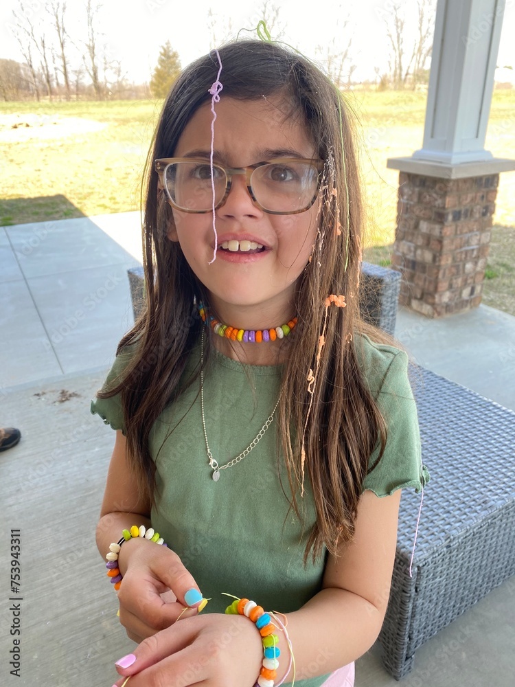 Silly string sprayed all over a preteen girl. Stock Photo | Adobe Stock