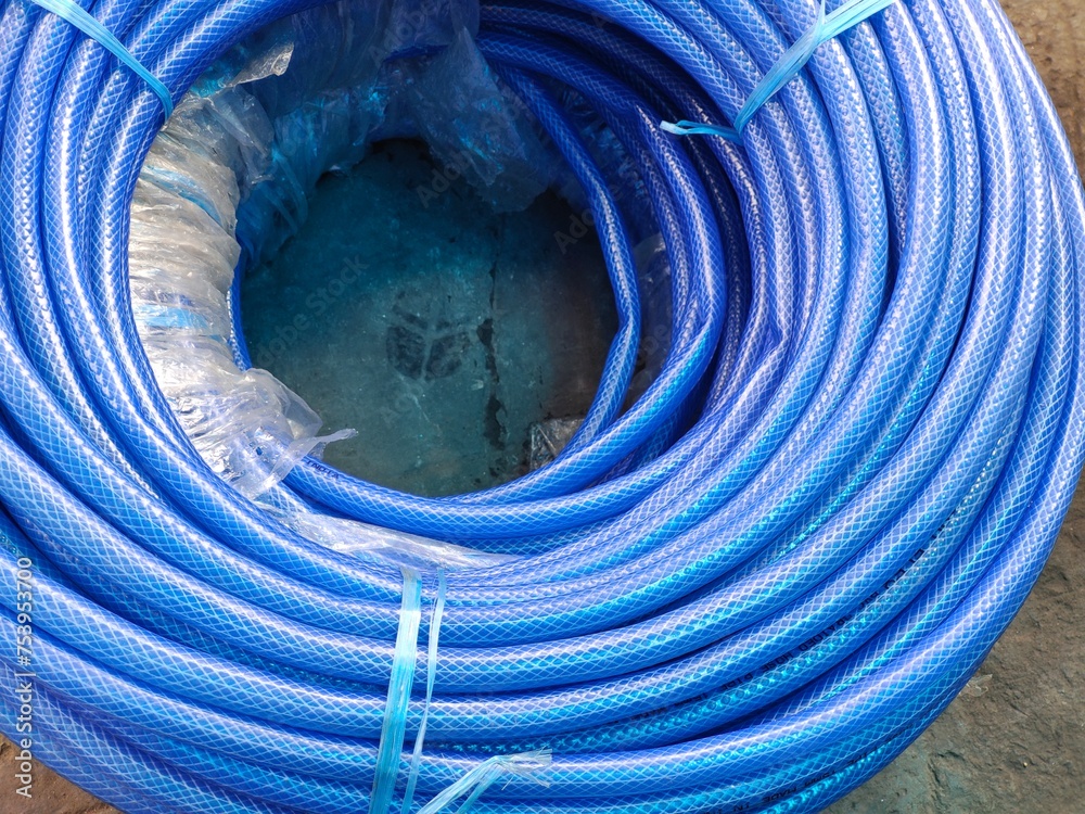 Blue colored cable stacked in spiral shape outside a shop for selling ...