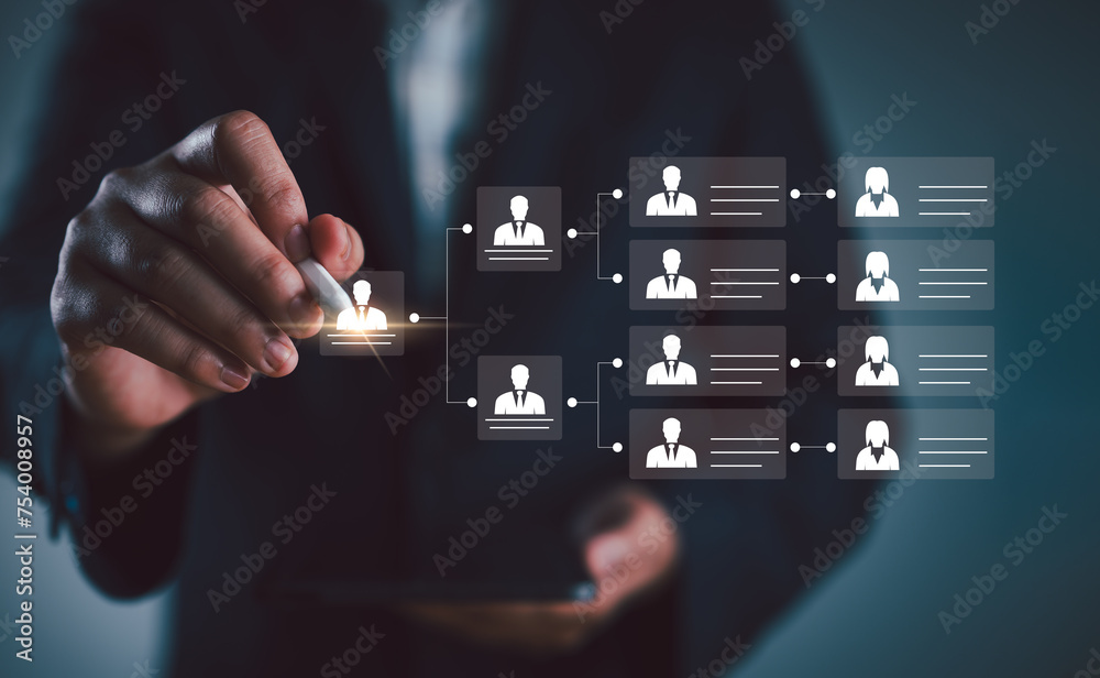 Organization chart, mind map. Businessman uses a pen to draw an ...