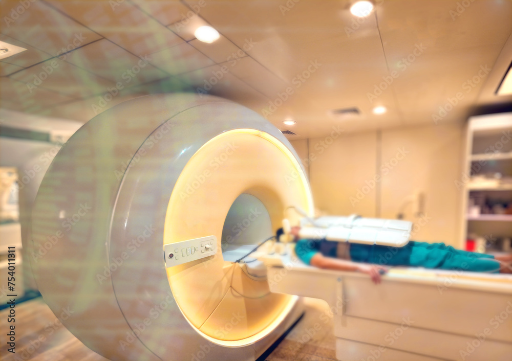 A patient lies down comfortably on the MRI scanner, undergoing a ...