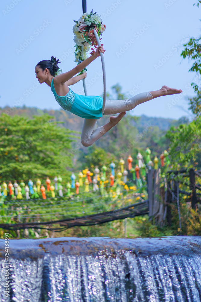 Beautiful Asian girl performing show aerial hoop or aerial ring in ...