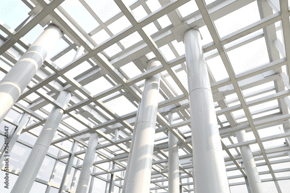 White steel frame structure with surrounding walls are lined with steel ...
