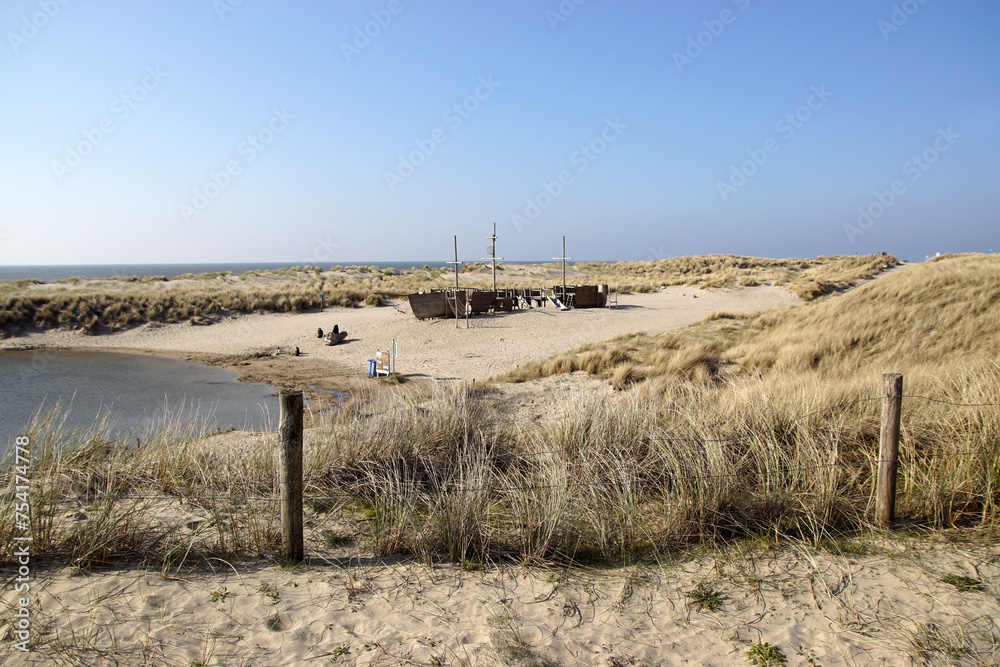 Dutch beach, playground with wooden boat next to the Camperduin lagoon ...