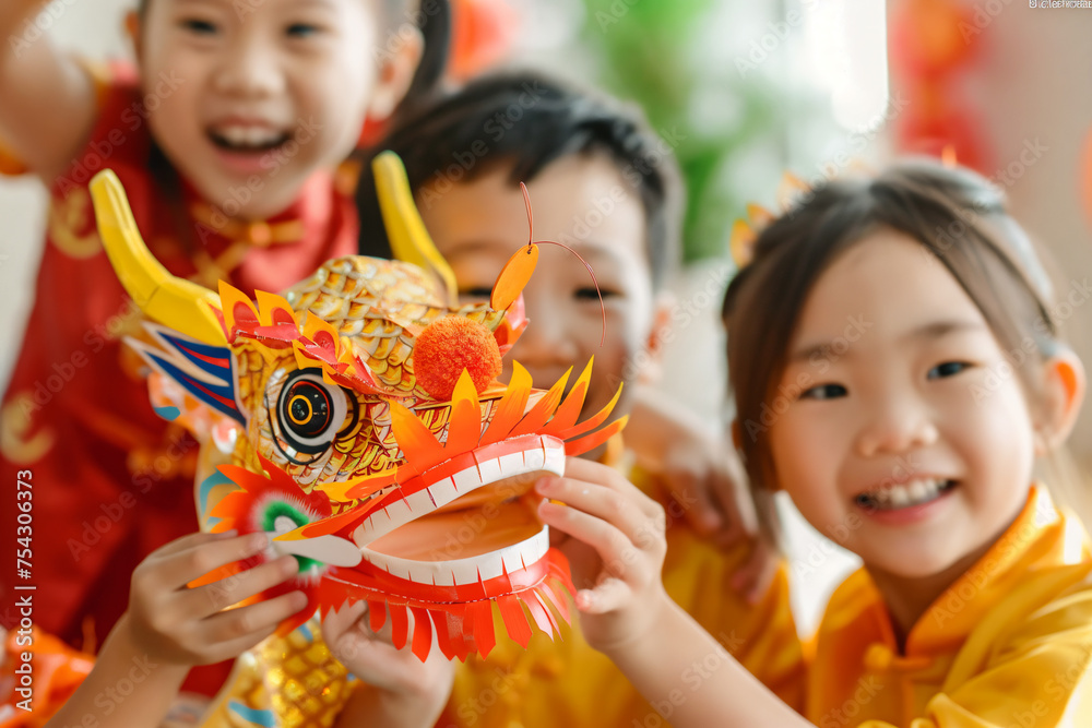 closeup Cute Asian children playing with a paper dragon while ...
