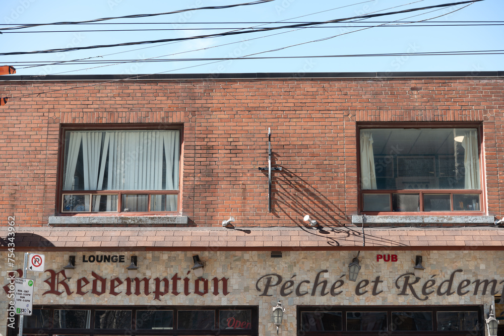 exterior building facade and sign of Sin & Redemption, a pub, located ...