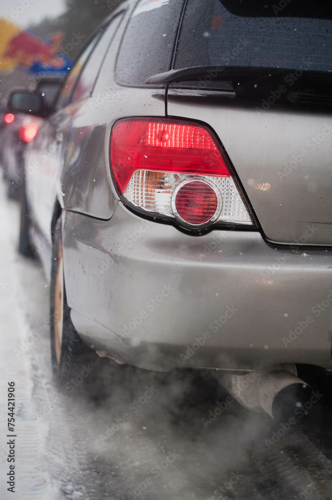 The sleek grey bumper of a car shines under the sunlight, adding modern ...