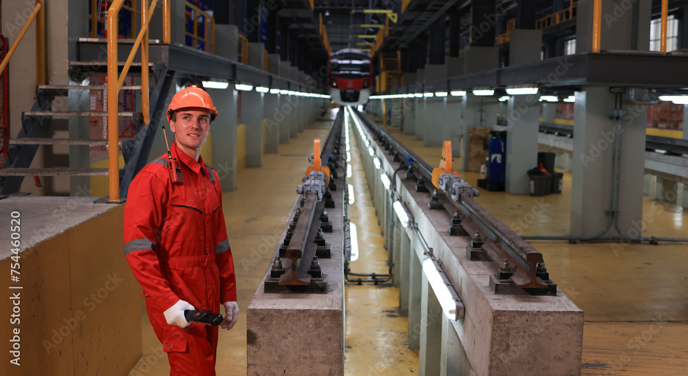 The portrait of a smart railway engineer with a full red safety suit ...