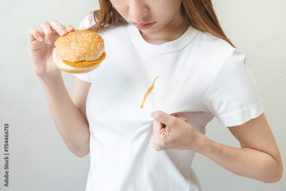 Clothes stain, disappointment asian young woman eat food hand hold ...