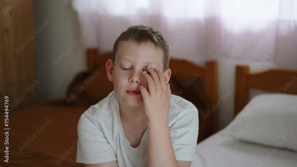Tired and sad child with allergic reaction and swollen face is sitting ...