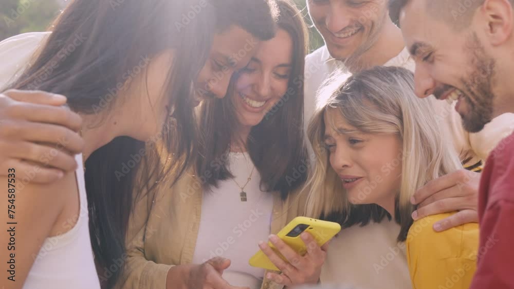 Young group of gen z people having fun using cell phone together ...