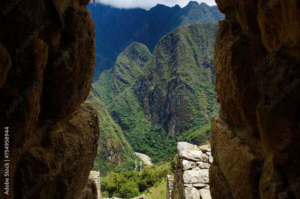 Panoramic view of the Peruvian Andes from a glimpse of a stone house in ...