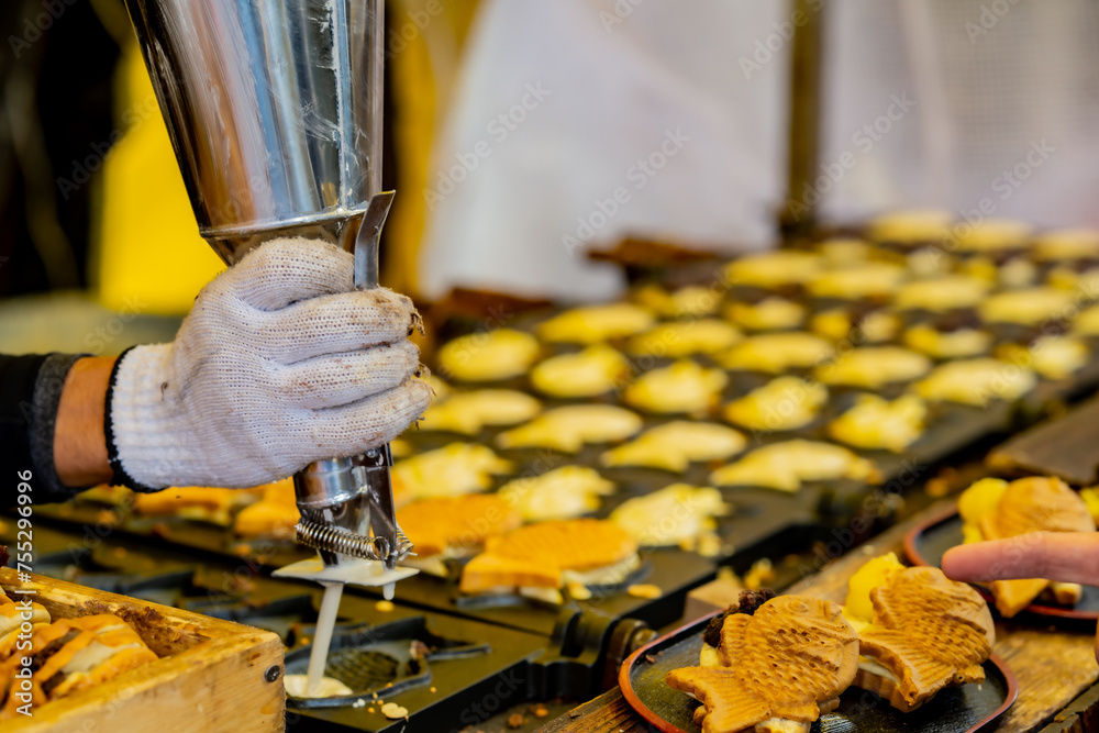 Japanese casual street food snack. Taiyaki. Red bean paste filling. a ...