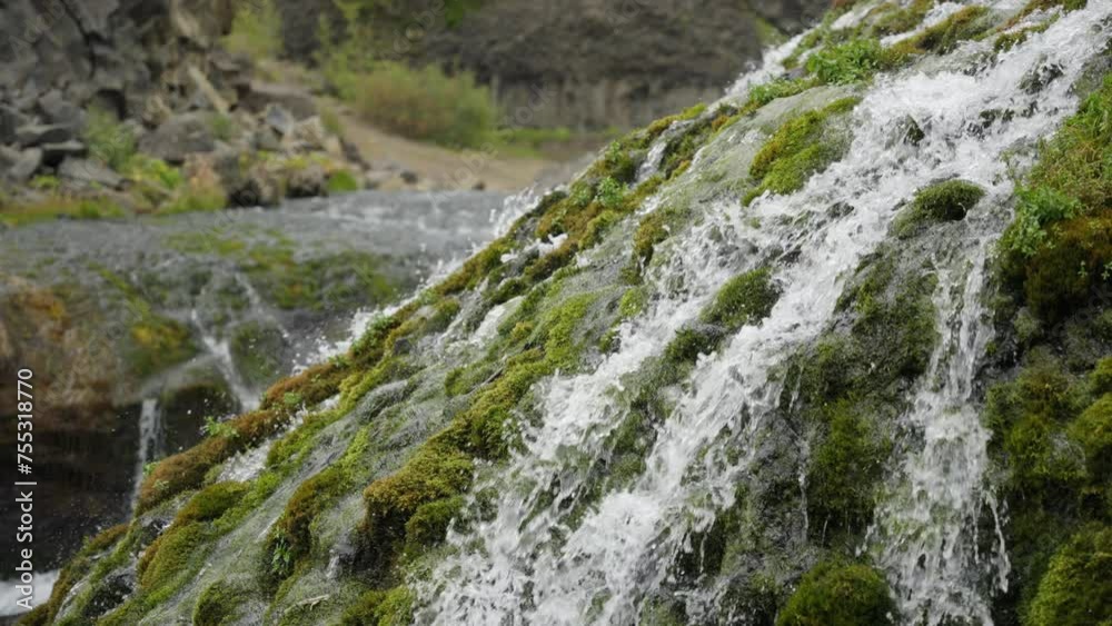 Close up of beautiful streams of small waterfalls run into a crystal ...