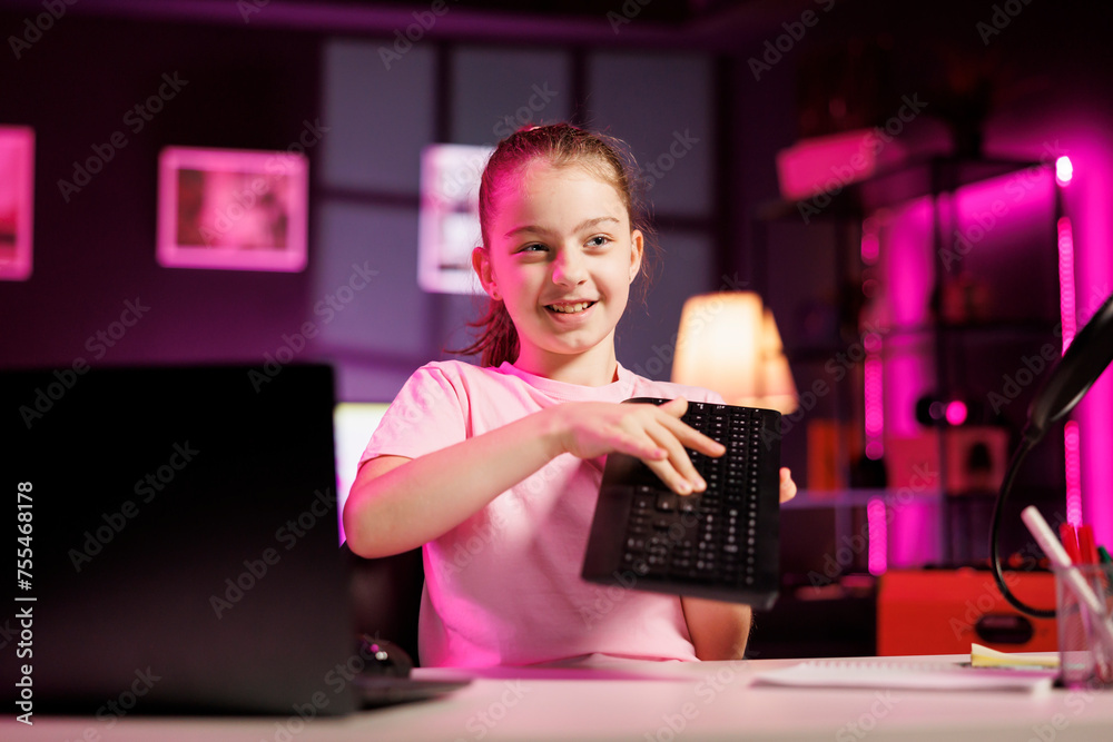 Child influencer filming wireless mechanical keyboard review in studio ...