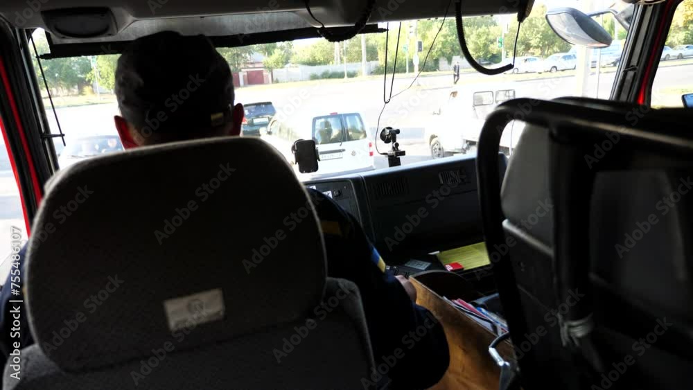 Young fireman controls a big truck riding to the place of fire ...