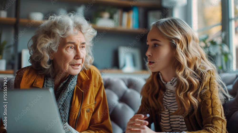 Grandma and granddaughter have an emotional conversation on the sofa in ...