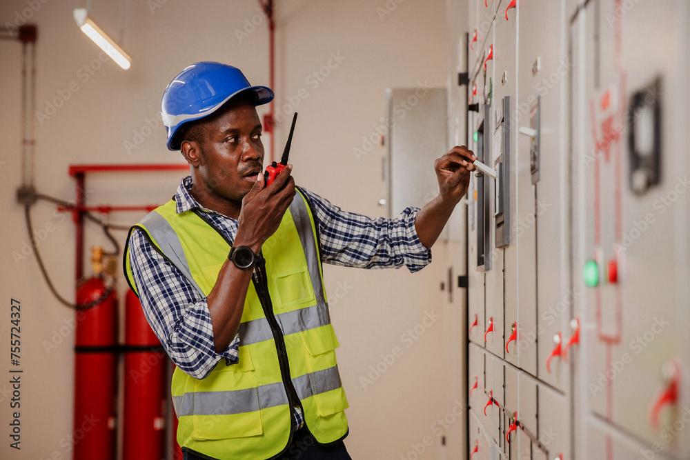 Electrical engineer working in control room. Electrical engineer man ...
