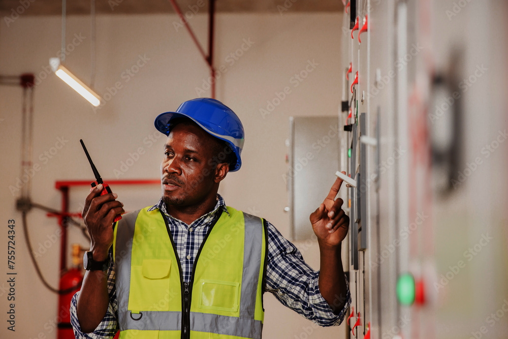 Electrical engineer working in control room. Electrical engineer man ...