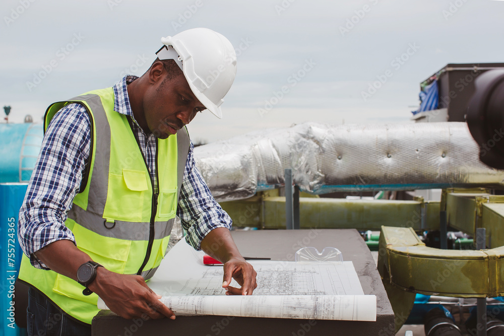 Engineers with draft plan of building on constructing site. Engineer ...