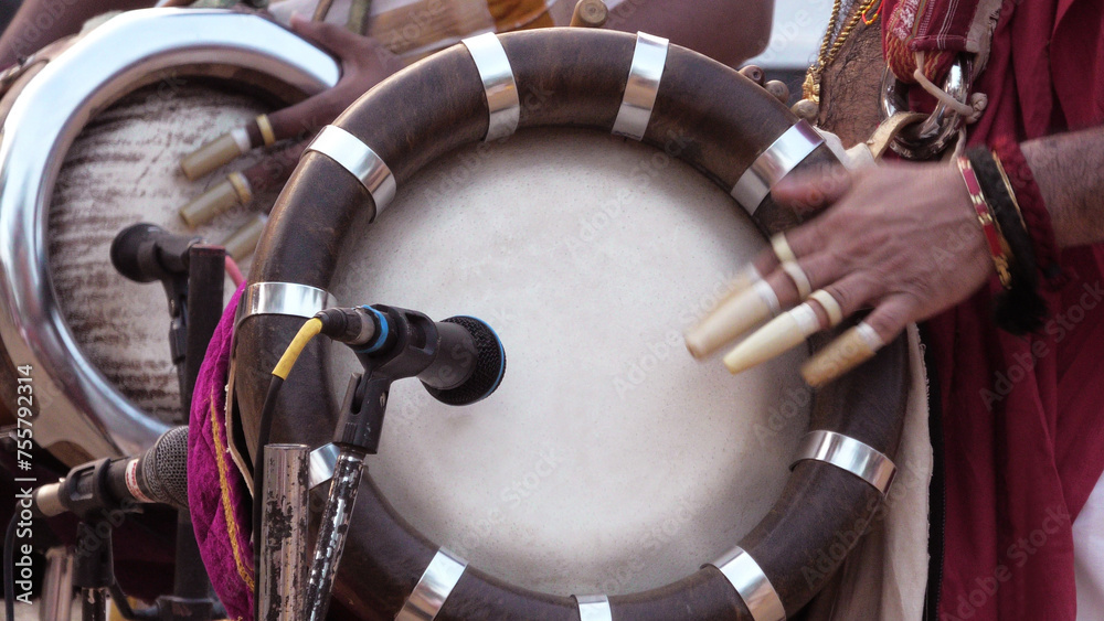 An artist playing Thavil, a South Indian percussion musical instrument ...
