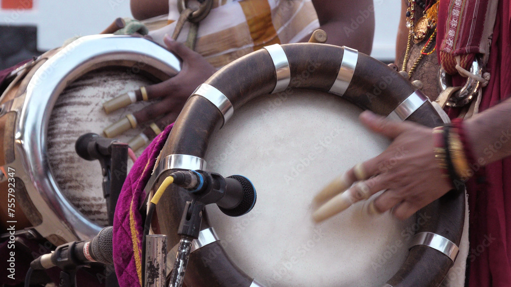 An artist playing Thavil, a South Indian percussion musical instrument ...
