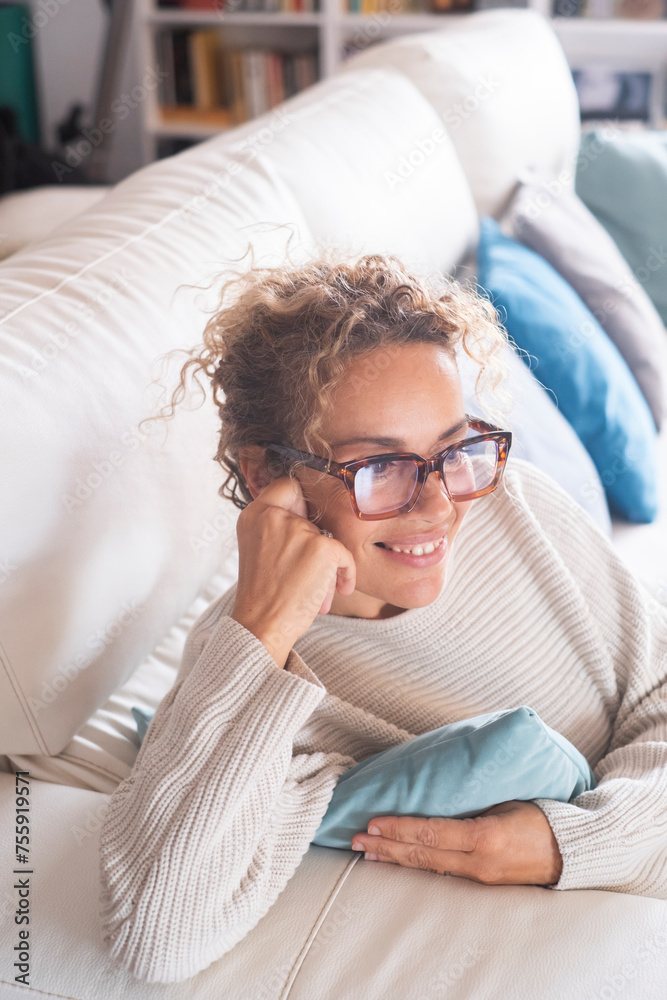 Young mature lady at home relaxing on the sofa at home in indoor ...