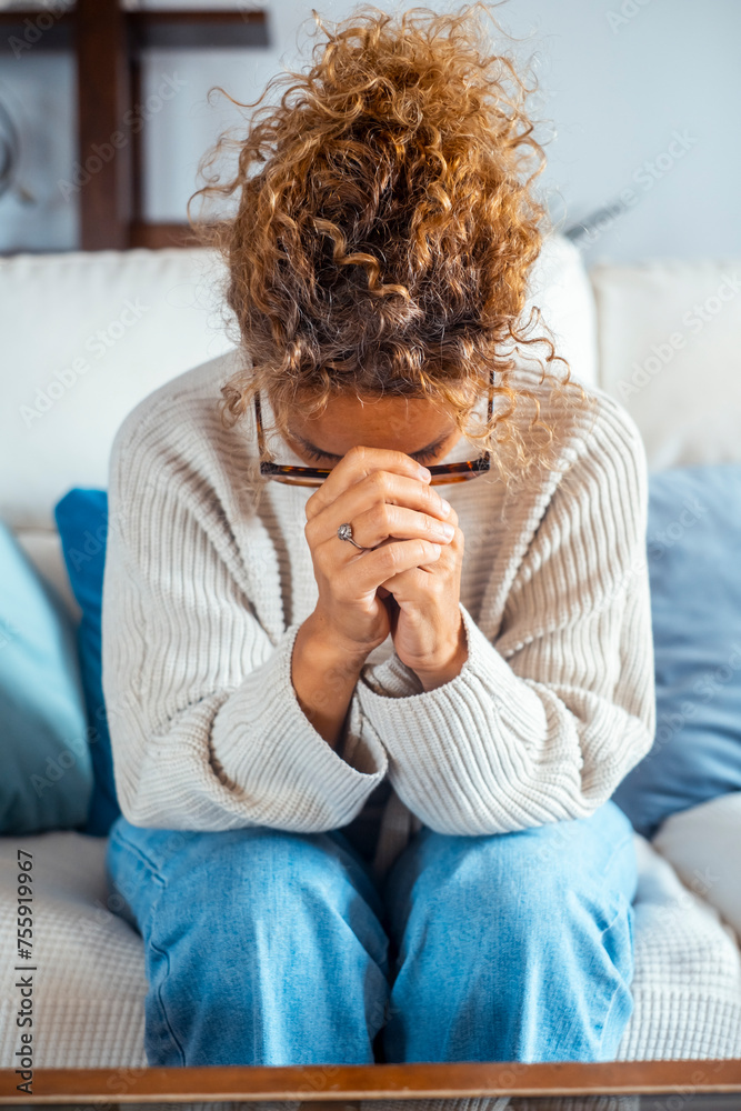 Frustrated and exhaust woman at home looking down on the floor sitting ...