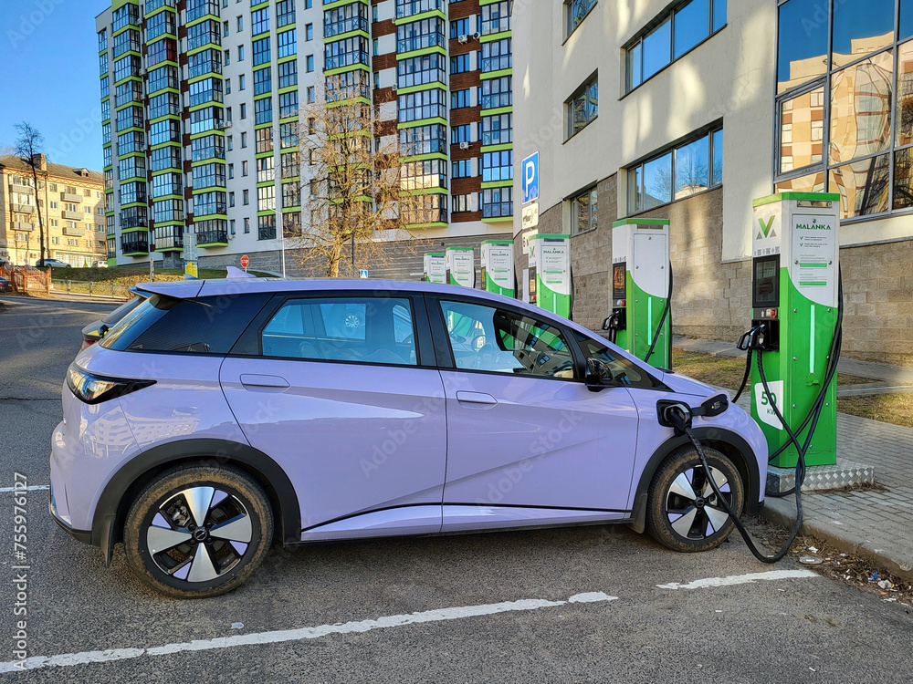 Minsk, Belarus. Mar 10.2024. Purple BYD Dolphin, electirc car charge ...