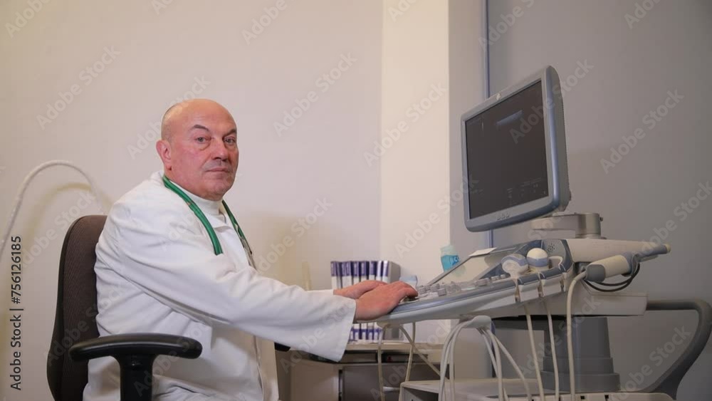 A professional doctor is sitting at a desk in front of a computer ...