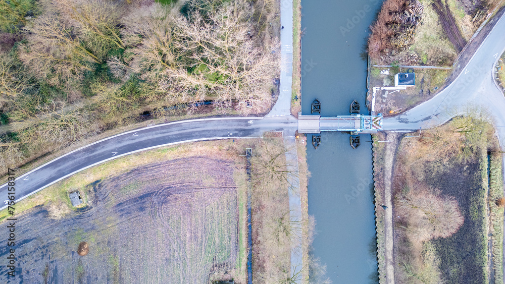 This image captures an aerial perspective of a canal intersecting with ...