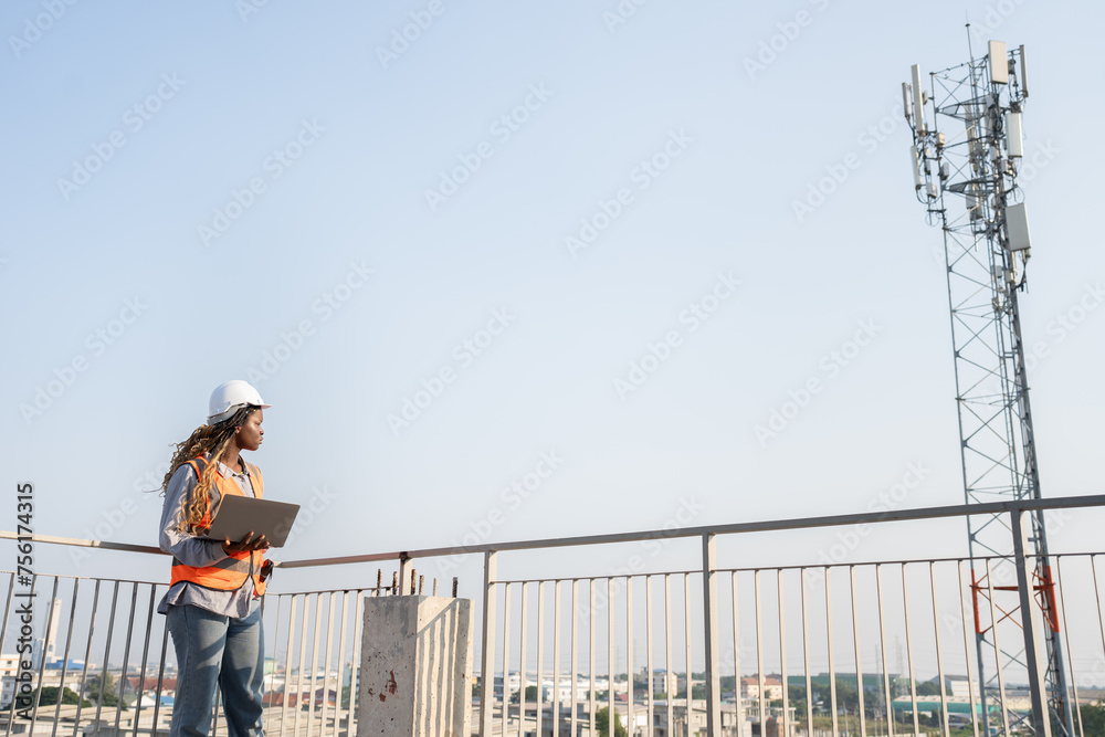 Portrait very tired worker African woman holding notebook computer and ...