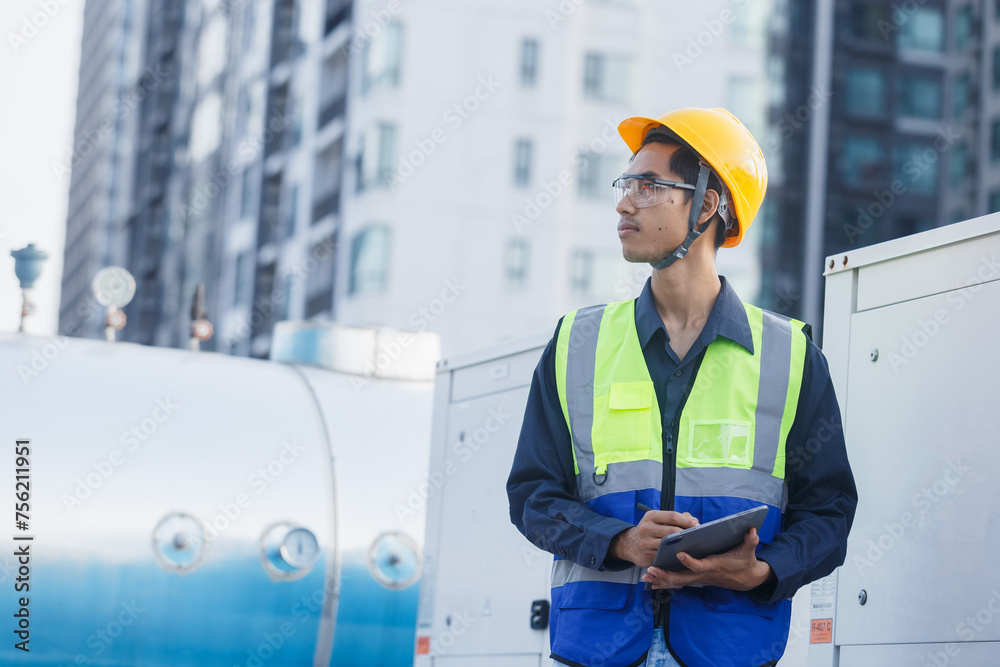 Man engineer holding tablet working at rooftop building construction ...