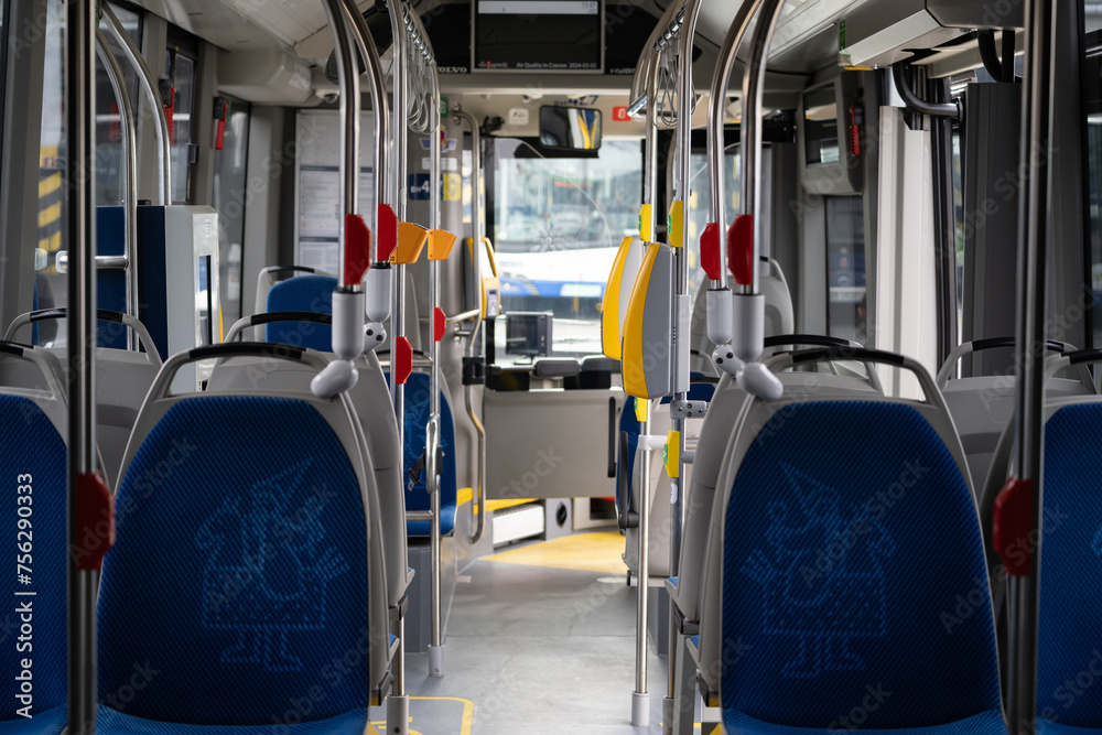 Inside view of passenger bus cabin with seats. Onboard autobus coach in ...