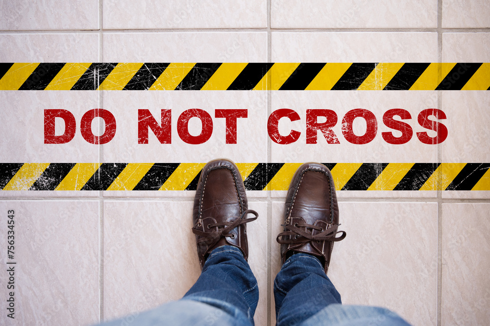 Legs in Jeans and brown leather shoes against tiled floor.Top dpwn shot ...