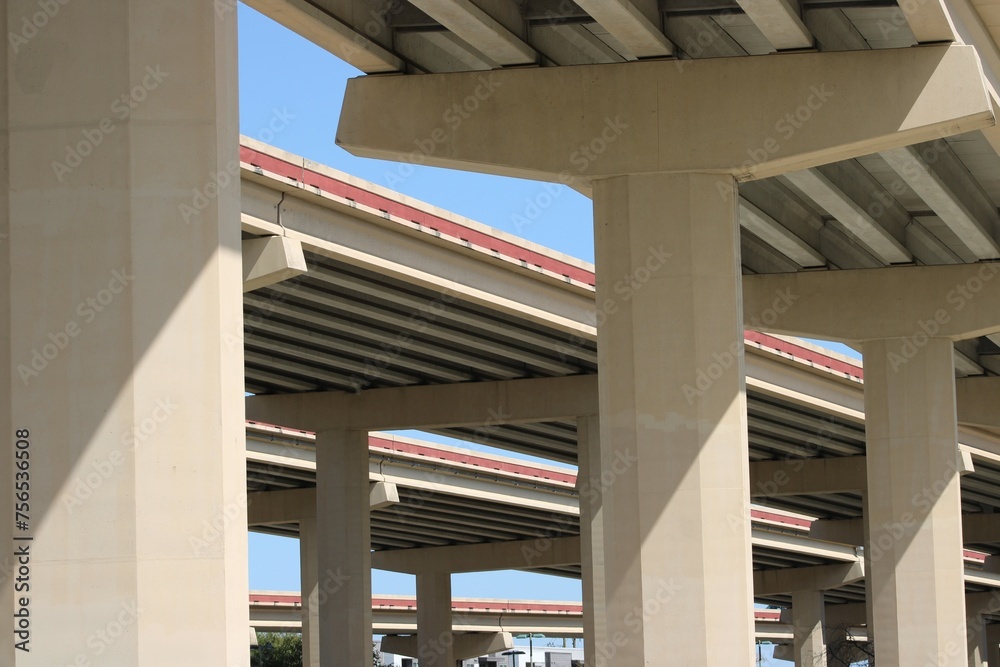 From the ground looking up three tiers of a busy turnpike, the sign ...