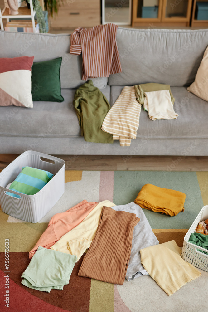 Background image of clean clothes sorted in stacks and storage boxes in ...