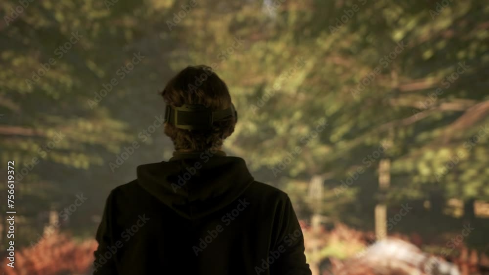 Man wearing virtual reality glasses stands in front of big digital ...
