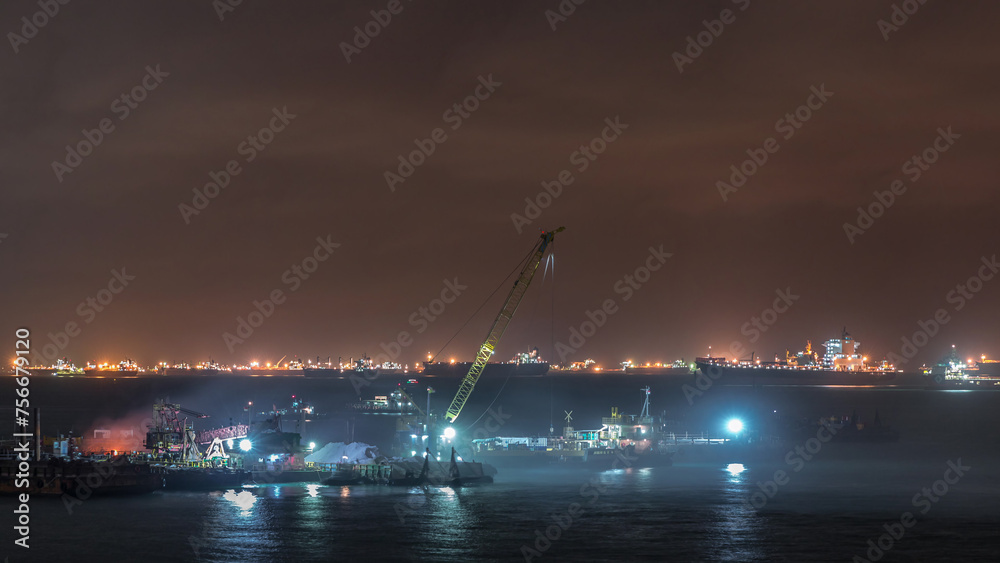 Singapore Marina Barrage with cargo ships waiting to enter one of the ...