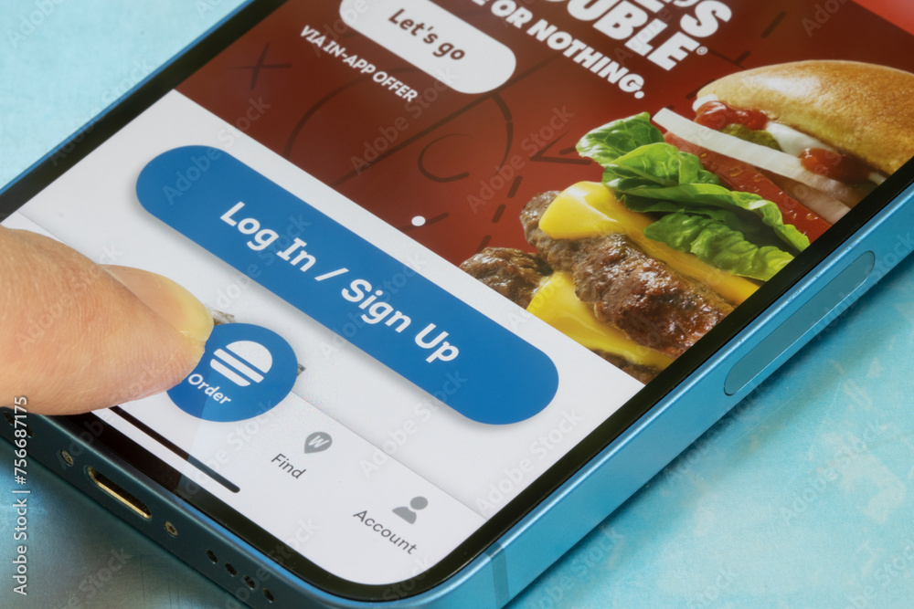 Portland, OR, USA - Mar 7, 2024: Finger touching the order button in ...