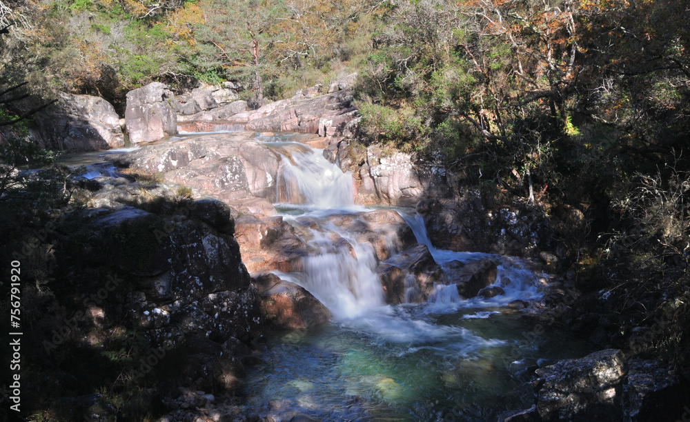 River that passes through rocks with waterfalls, Gerês mountain in ...