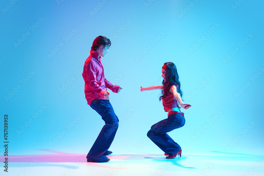 Happy, positive young man and woman in retro clothes dancing boogie ...