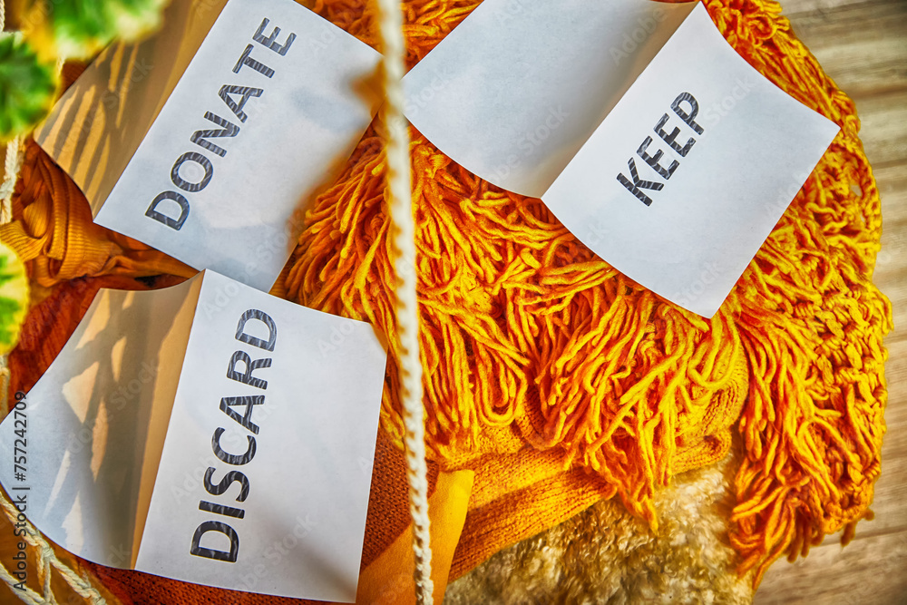 Signs with the words keep, donate, discard and fashion clothes folded ...