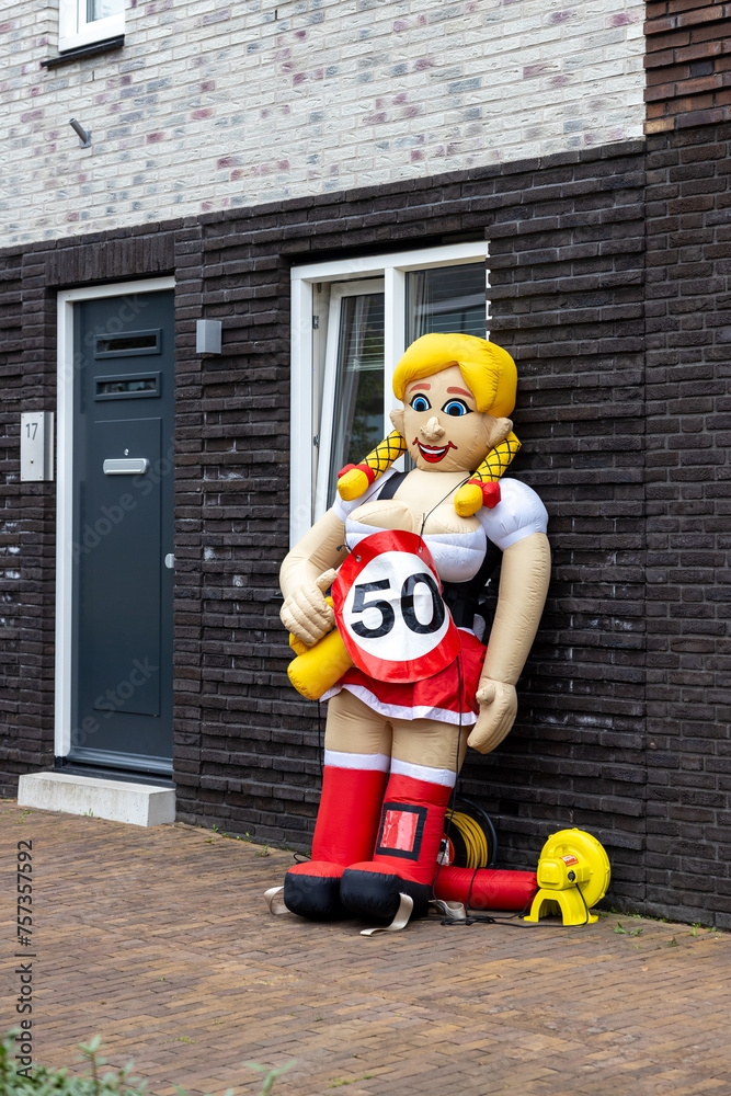 Traditional Dutch Sarah doll in front of the door of a house where a ...
