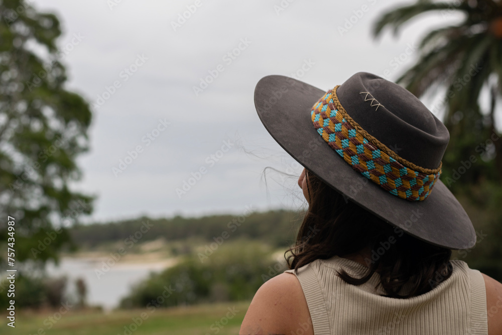 Latin woman wearing a traditional hat worn by gauchos in Uruguay and ...
