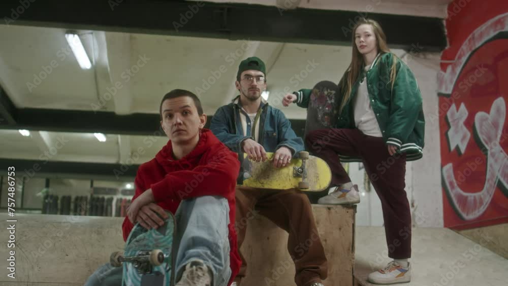Team of young gen Z skateboarders in streetwear posing together for ...