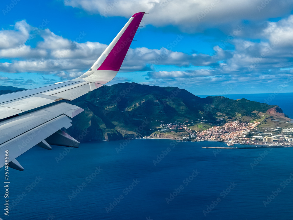 Aerial window view from an airplane on coastal town Canical, Madeira ...