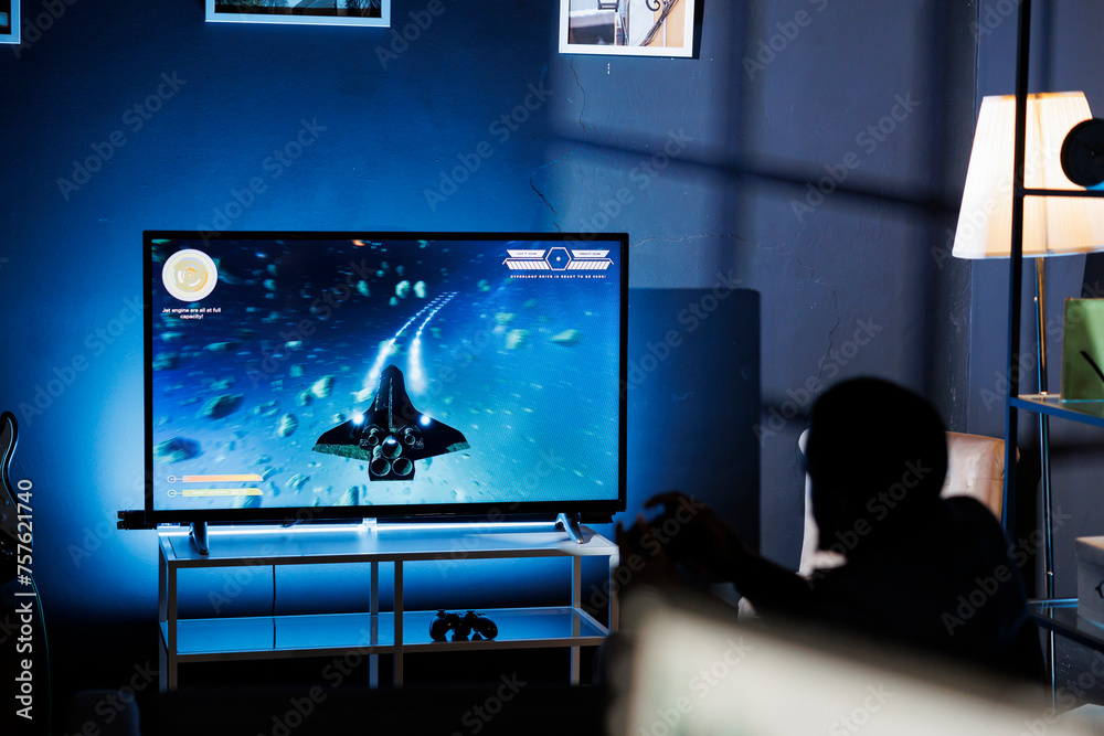 Young guy having fun with video games on television, connecting his ...