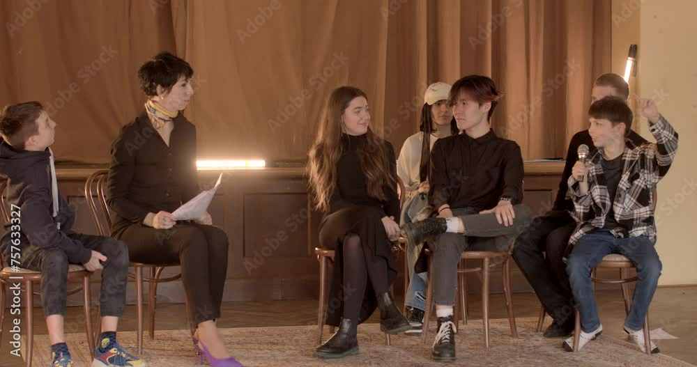 Children, teens and young students participate by raising hands to ...