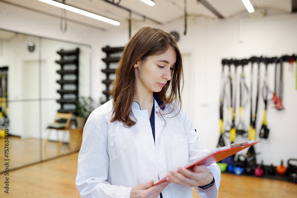 Rehab doctor is on appointment of patient in gym. PMR specialized in ...